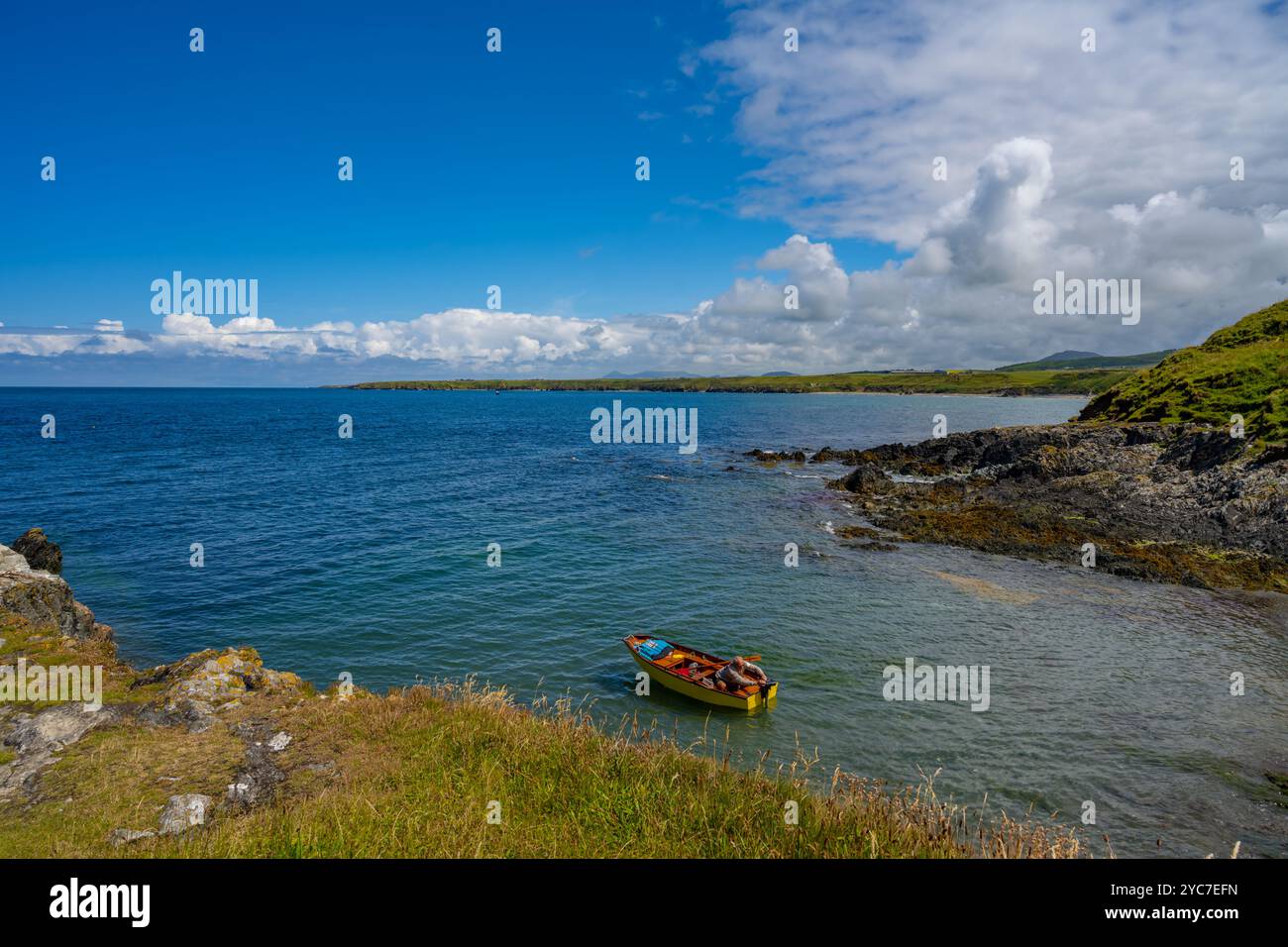 Fishing boat heading out to sea from Porth Colmon Llyn peninsula Wales ...