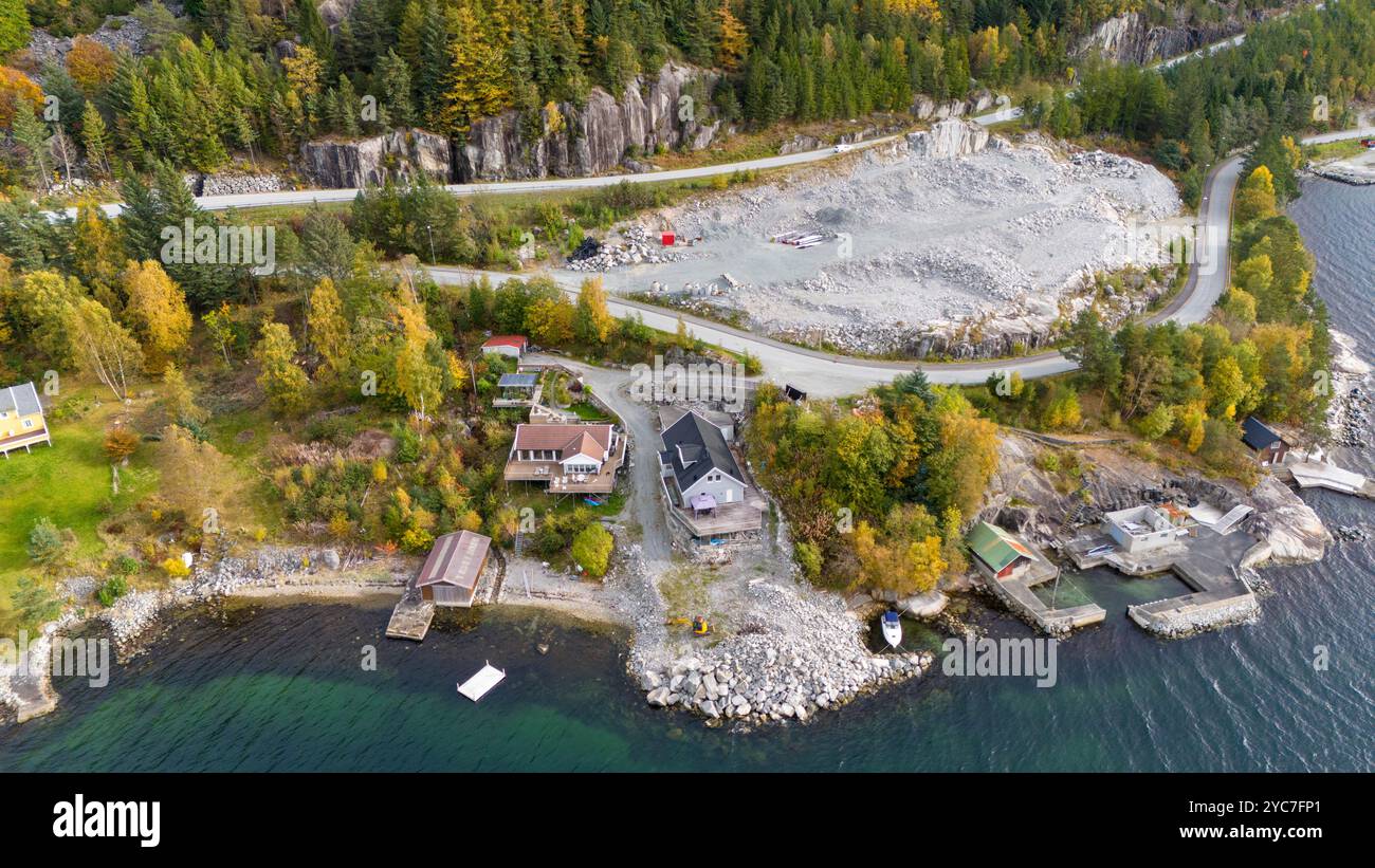 Aerial view of a coastal area with houses, a rocky shoreline, and a ...