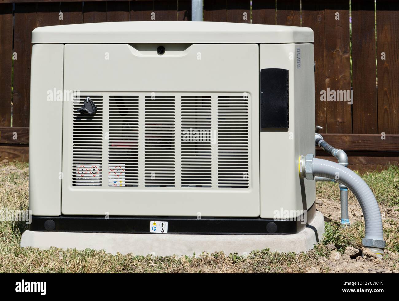 Standby home generator set in residential backyard, emergency backup ...
