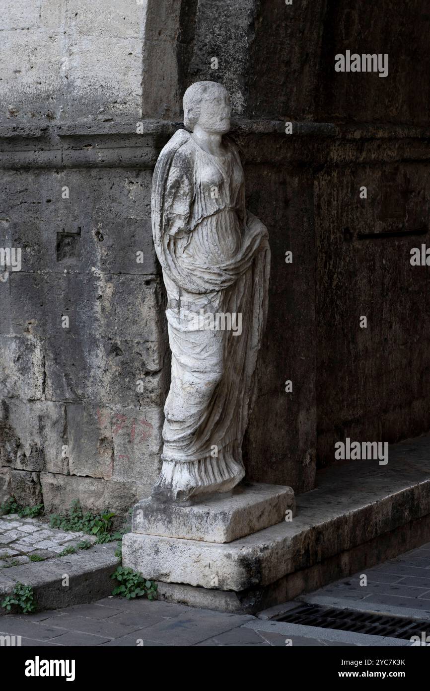 Roman toga-wearing statue from the forum area, Bell tower and arch of ...