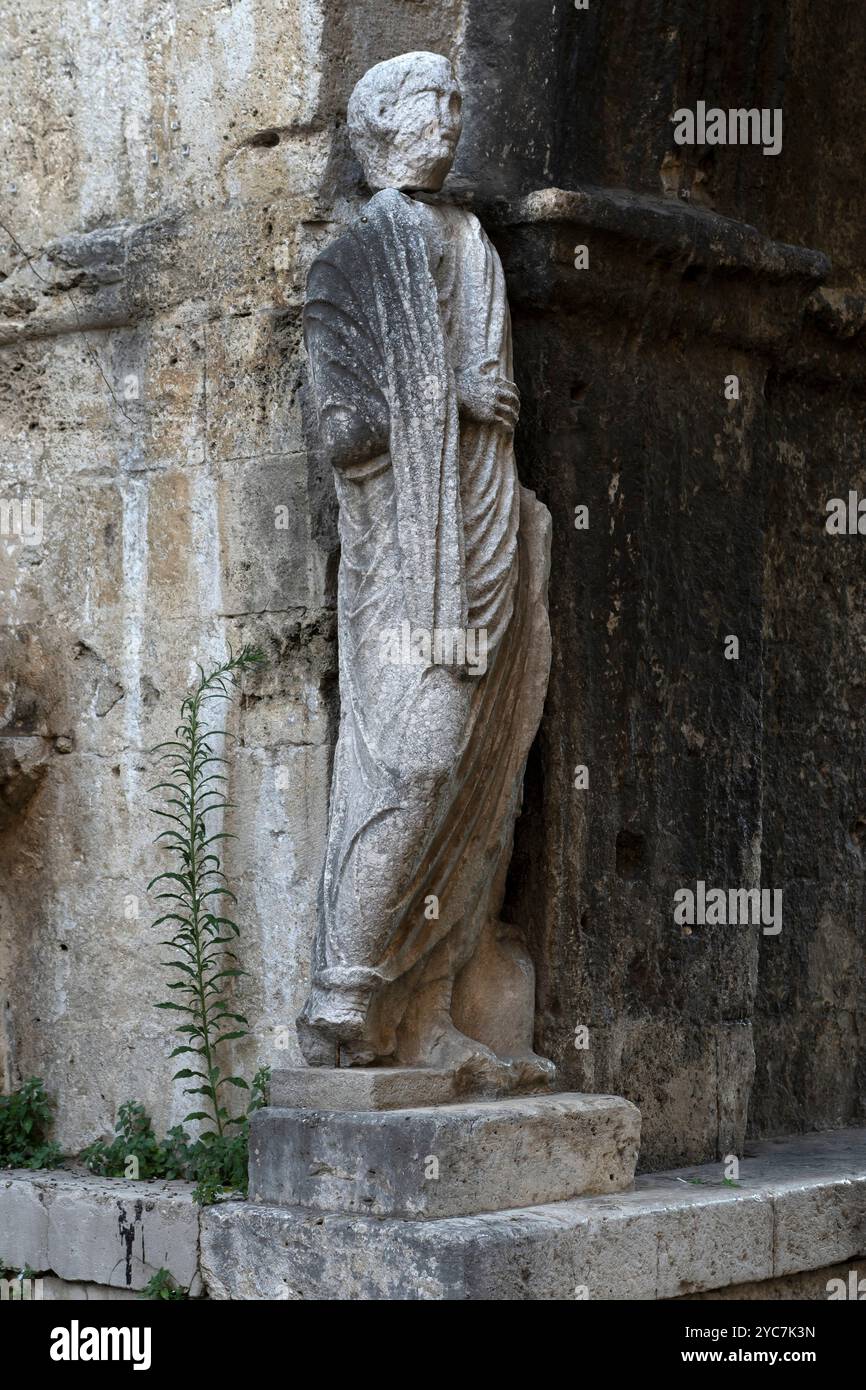 Roman toga-wearing statue from the forum area, Bell tower and arch of ...