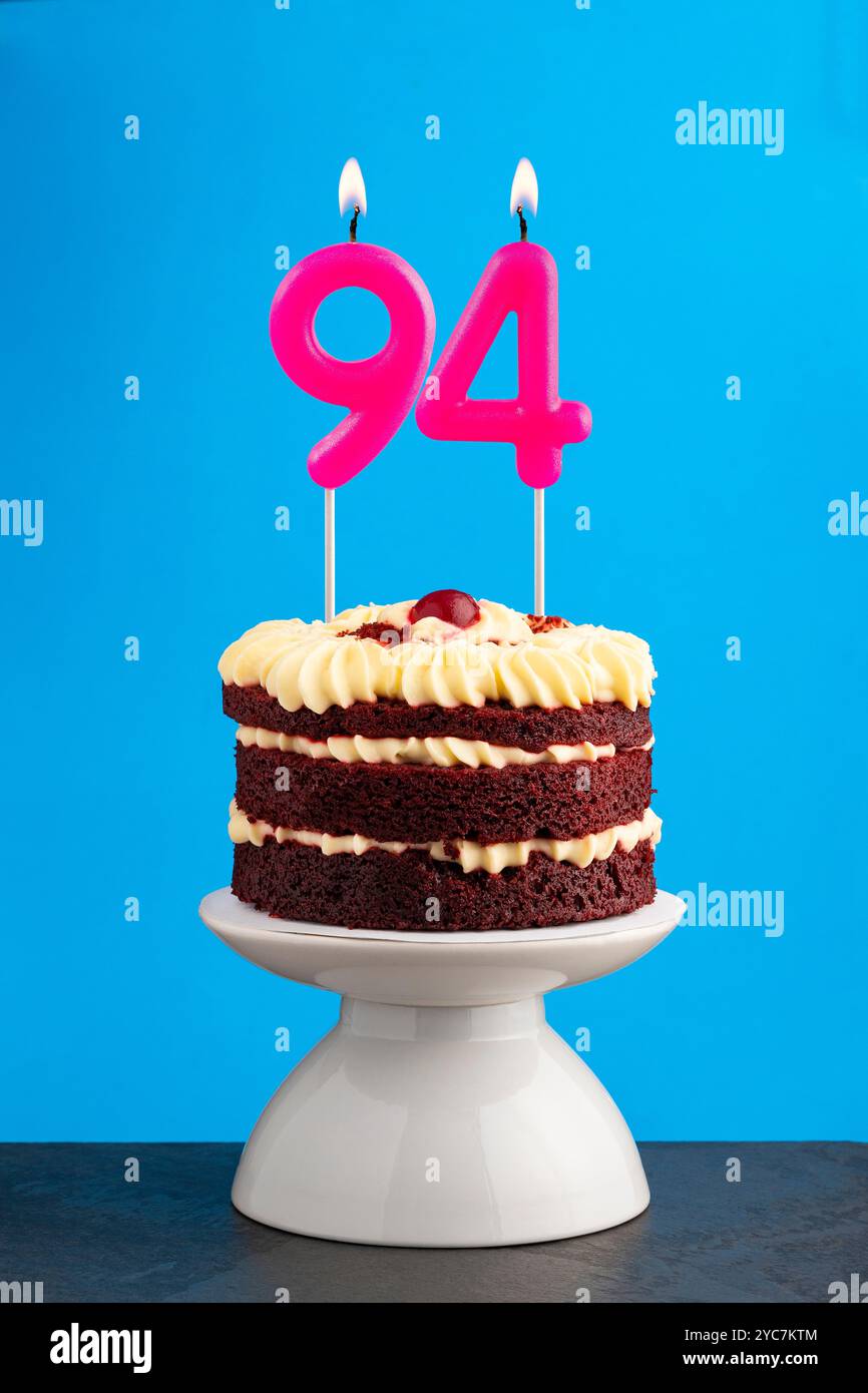 Red velvet birthday cake with number 94 candle Stock Photo - Alamy