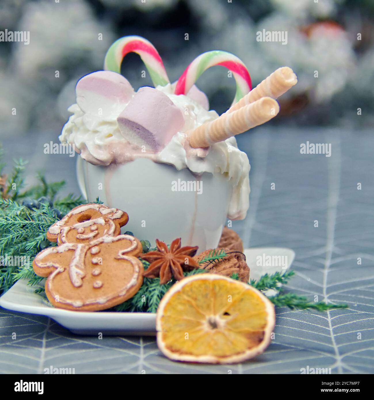 The cup contains cocoa, decorated with whipped cream and marshmallows ...