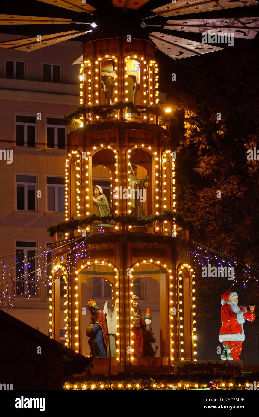 A multi-tiered rotating Christmas pyramid containing images of saints ...