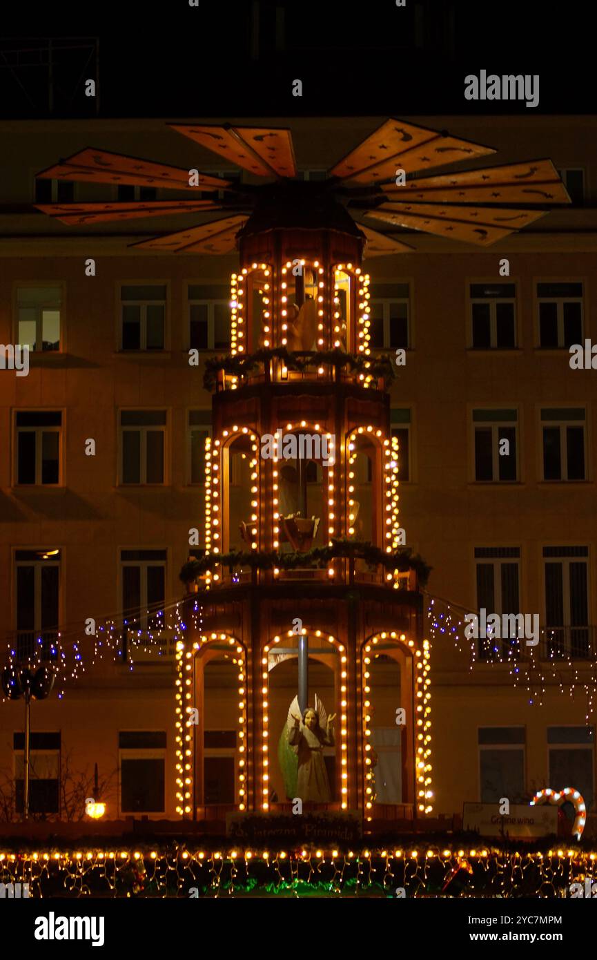 A multi-tiered rotating Christmas pyramid containing images of saints ...