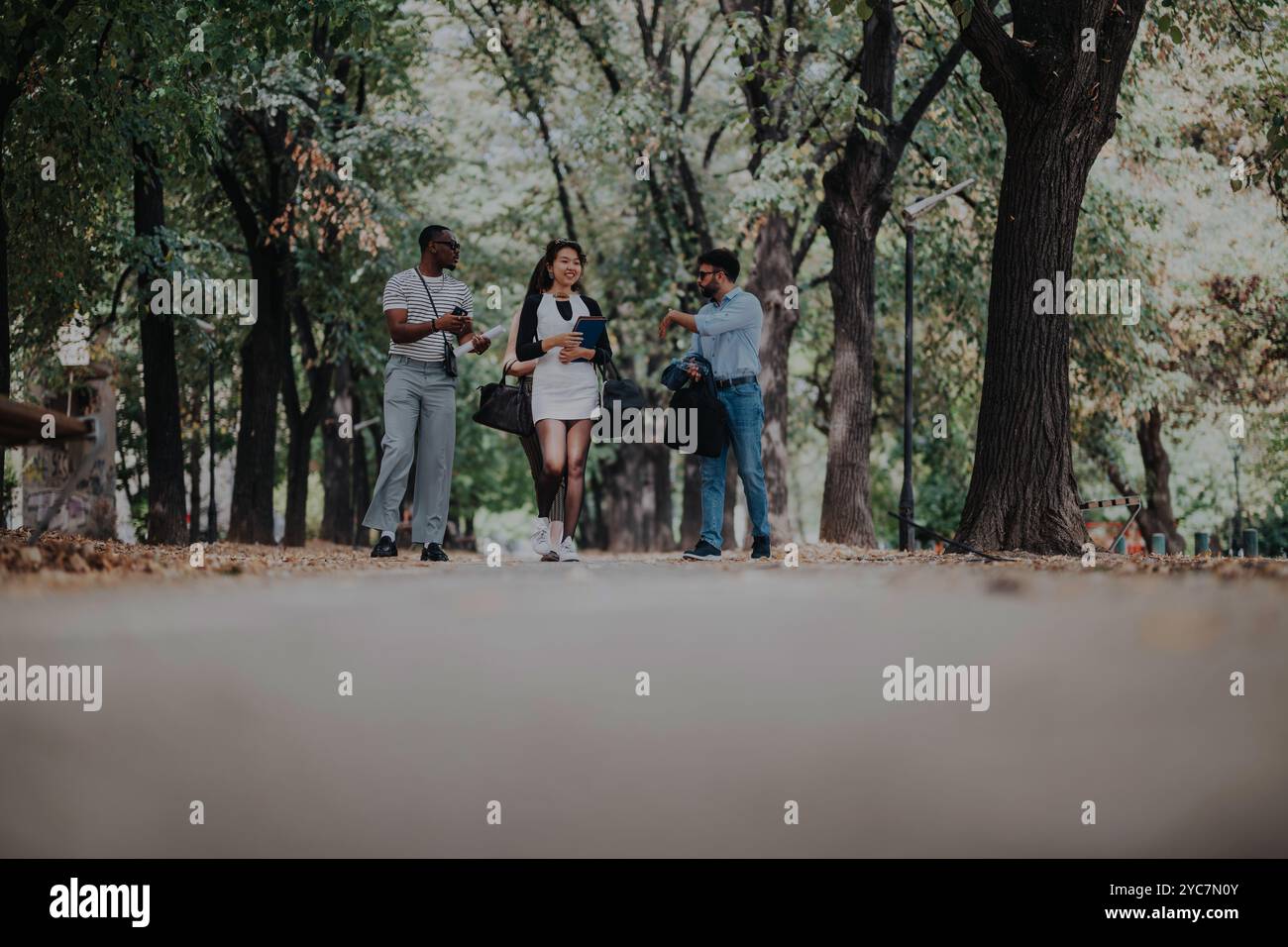 Business people engaging in an outdoor conversation in a park setting ...