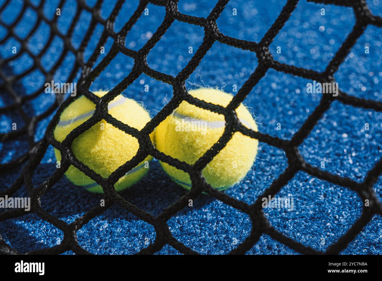 two balls behind the net on a paddle tennis court, racket sport ...