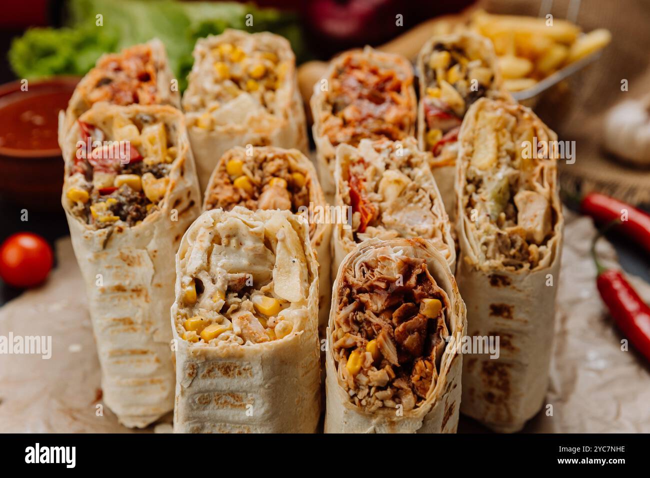 Assorted grilled wraps with diverse fillings, perfect for a party ...