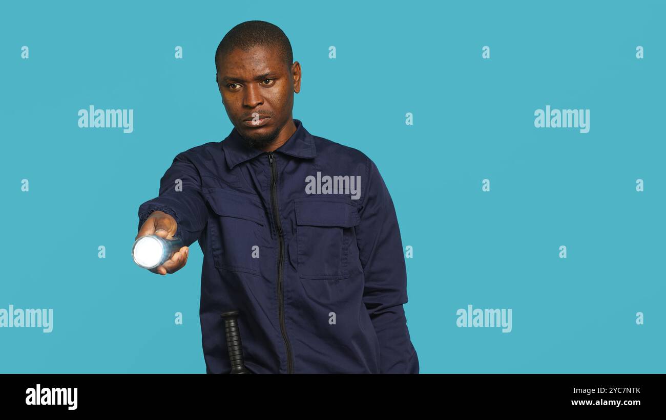 Security guard turning on flashlight, being tasked with preventing ...