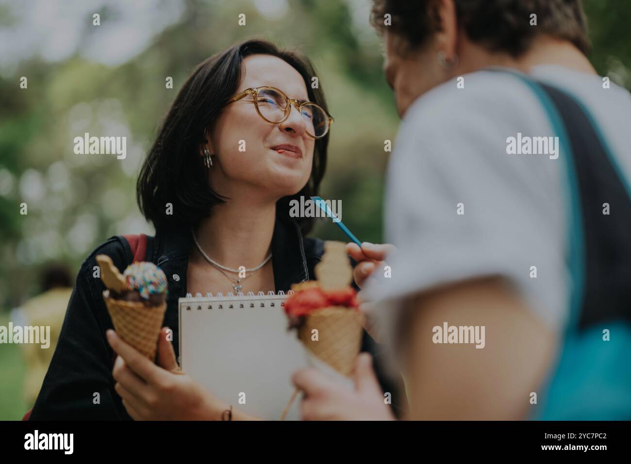 Multicultural students enjoying ice cream in the park during class break Stock Photo - Alamy