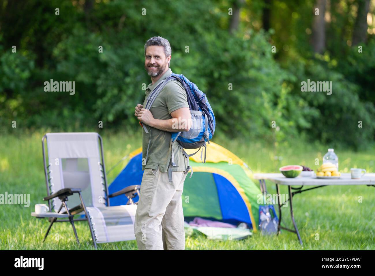 Hiking concept. Camping tent. Man on camp in the forest with tent. Man ...