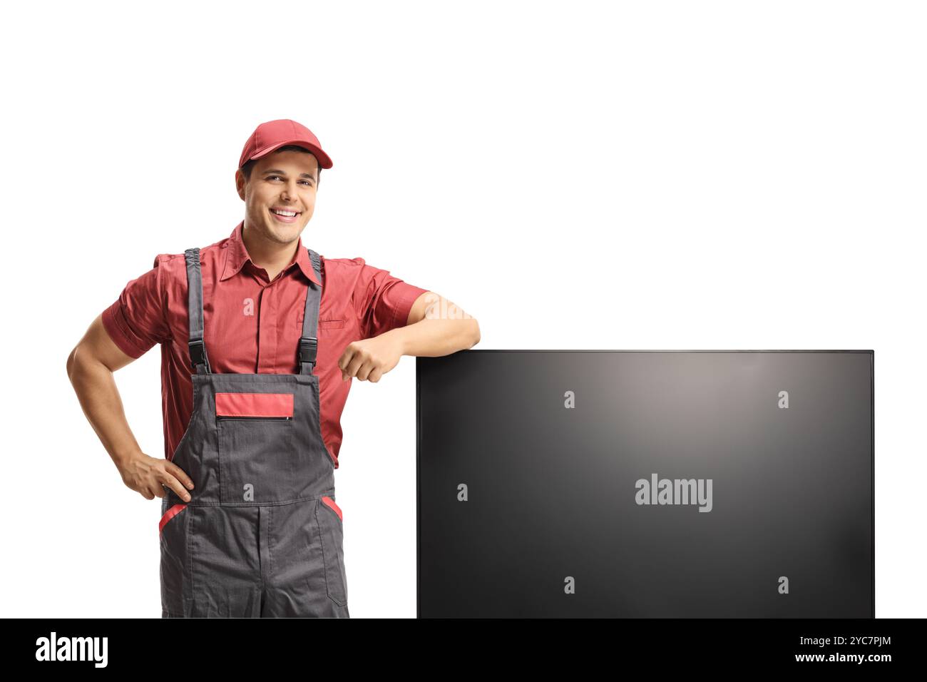 Handyman in a uniform standing next to a tv screen isolated on white ...