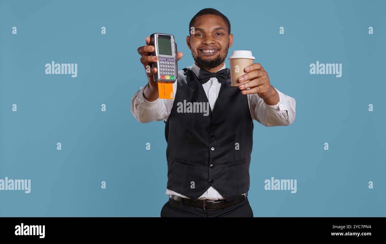 Hotel porter showing the pos terminal with card to symbolize electronic ...