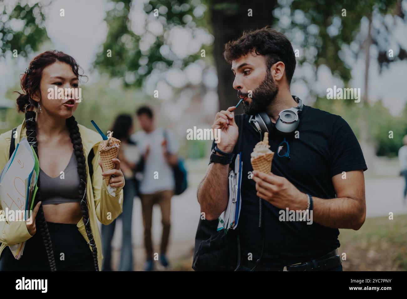 Multicultural students enjoying ice cream in park during break Stock Photo - Alamy