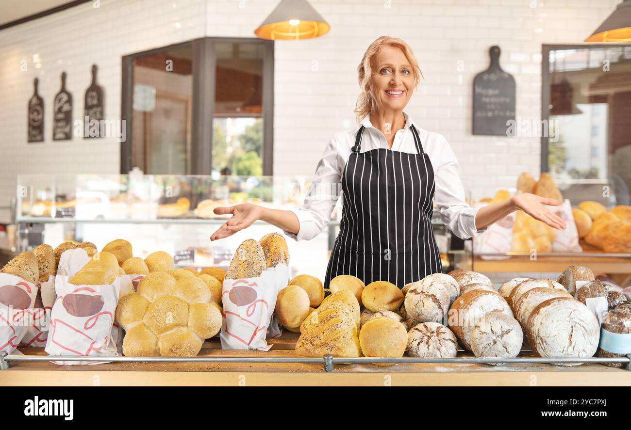 Bakery owner posing with breds on shelves, small local business support ...