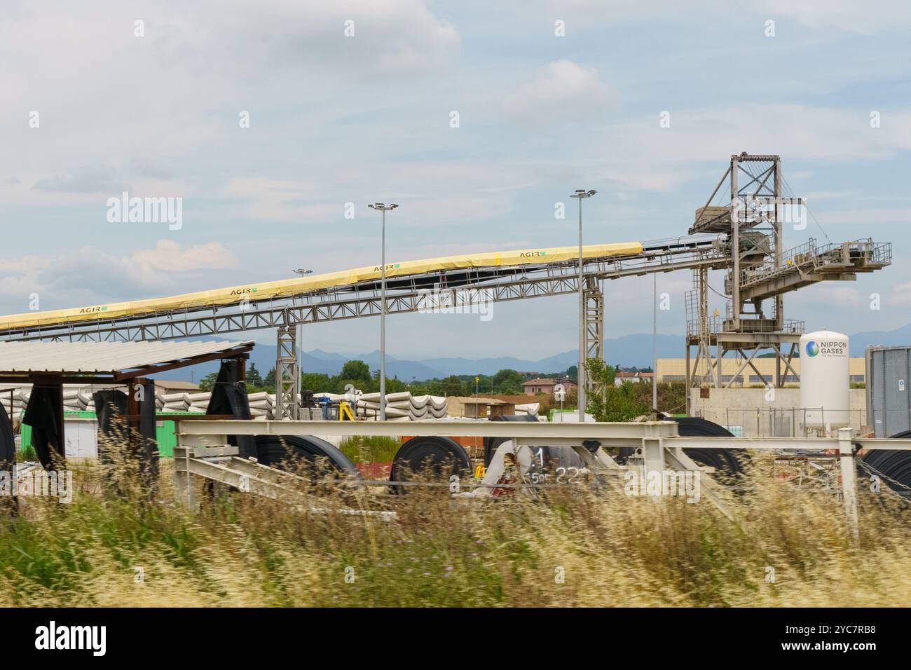 Brescia, Italy - June 13, 2023: Tall machinery looms over the landscape ...