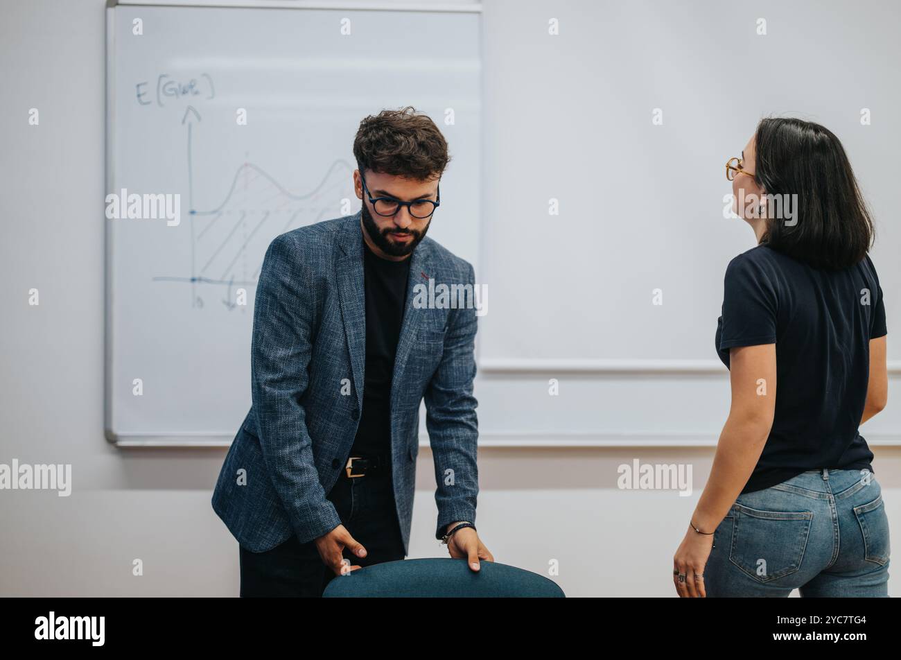 Two students engaging in an academic discussion in classroom Stock ...
