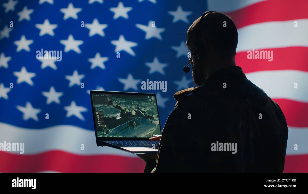 US Air Force dispatcher looking at surveillance transmission on device ...