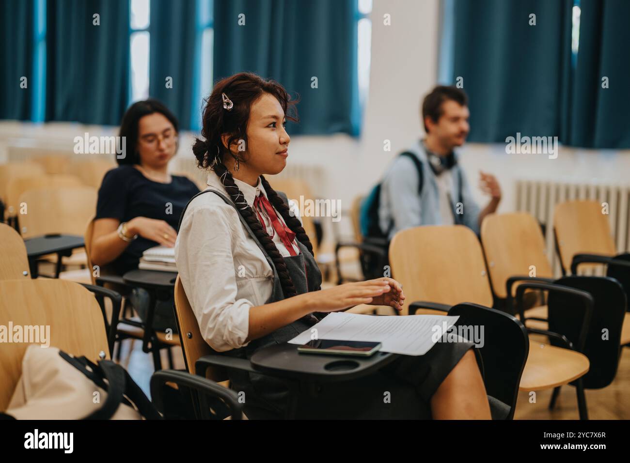 Students engaging with professor during break in university classroom Stock Photo - Alamy