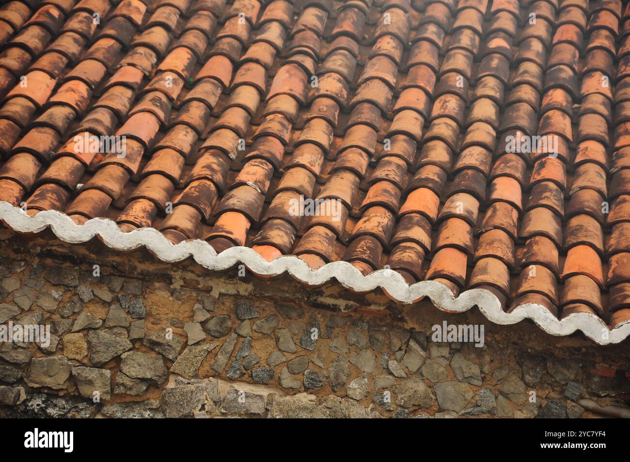 Rustic clay tile roof and stone wall, traditional architectural charm ...
