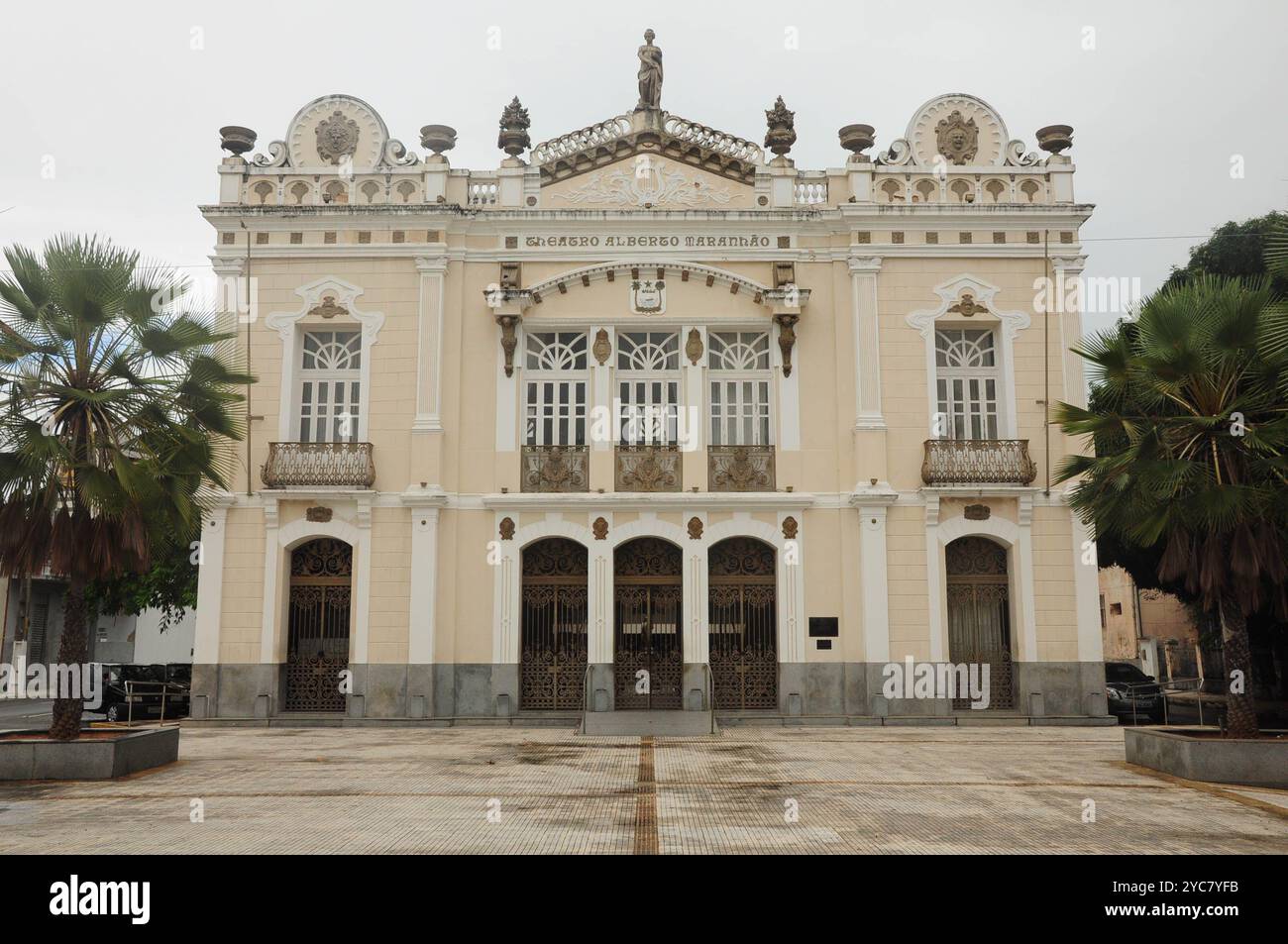 Neoclassical theater facade with ornate details and palm trees Stock ...