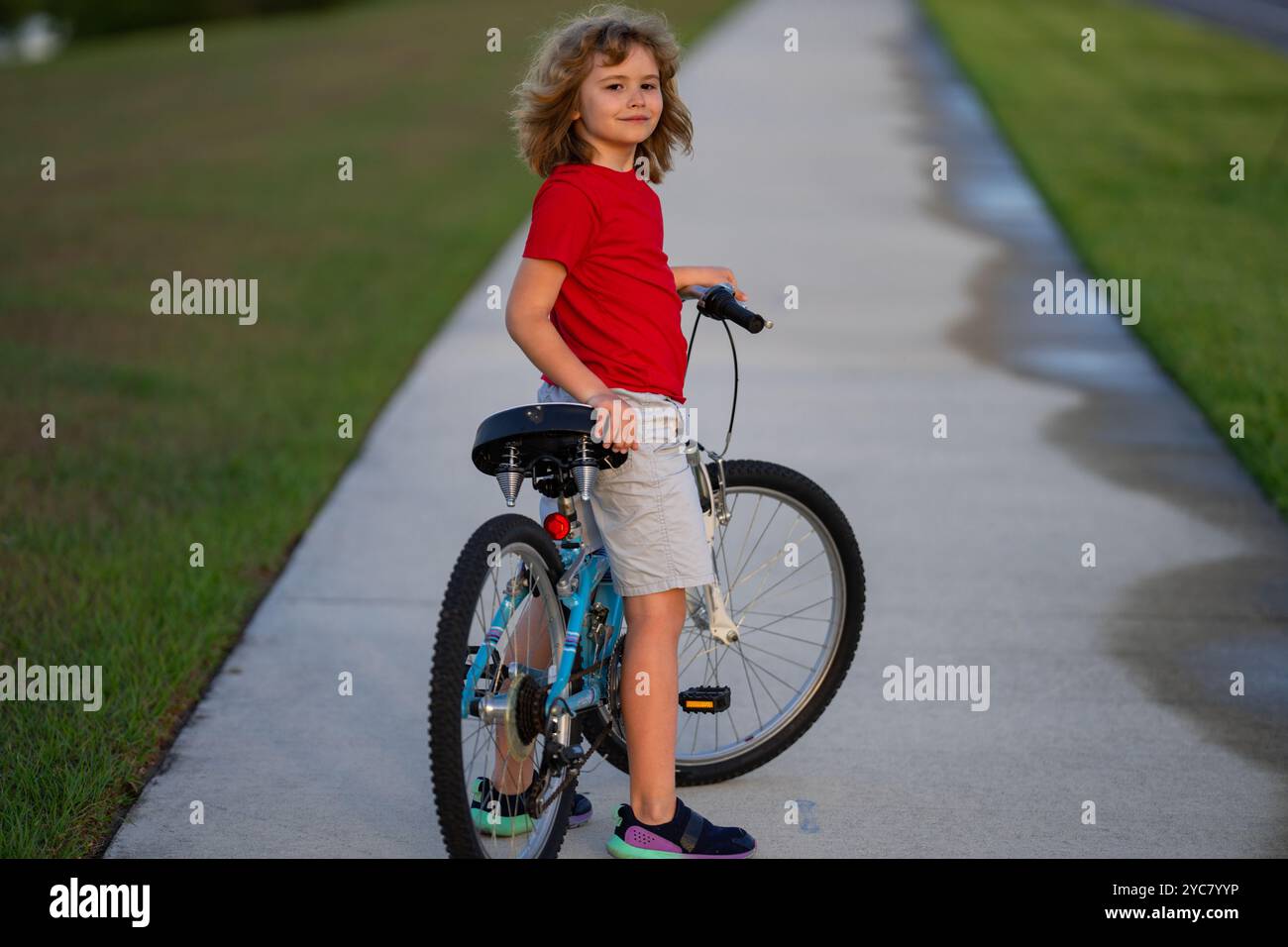 Kid riding bike in a helmet. Child riding bike outdoor. Safety kids ...