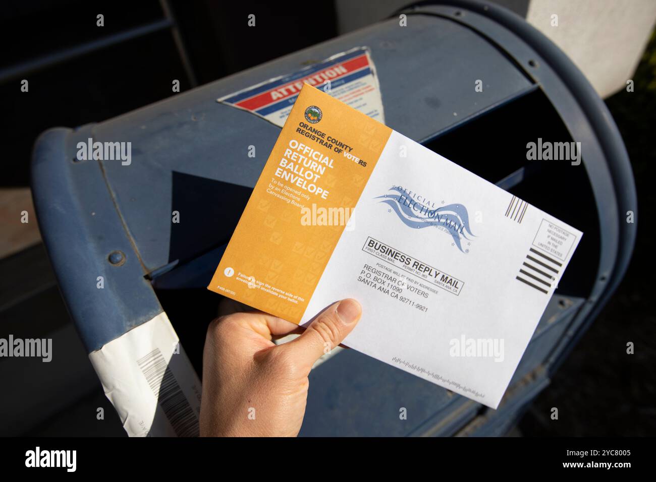 Fullerton, California, USA - October 20, 2024: A Caucasian hand drops a ...