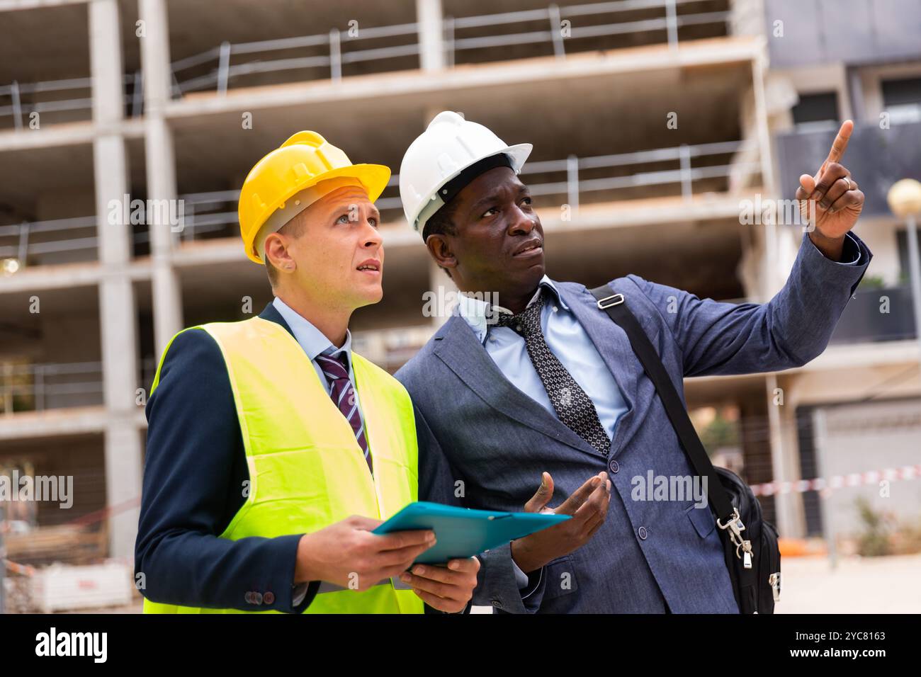Two architect, civil engineer or building contractor colleagues on ...