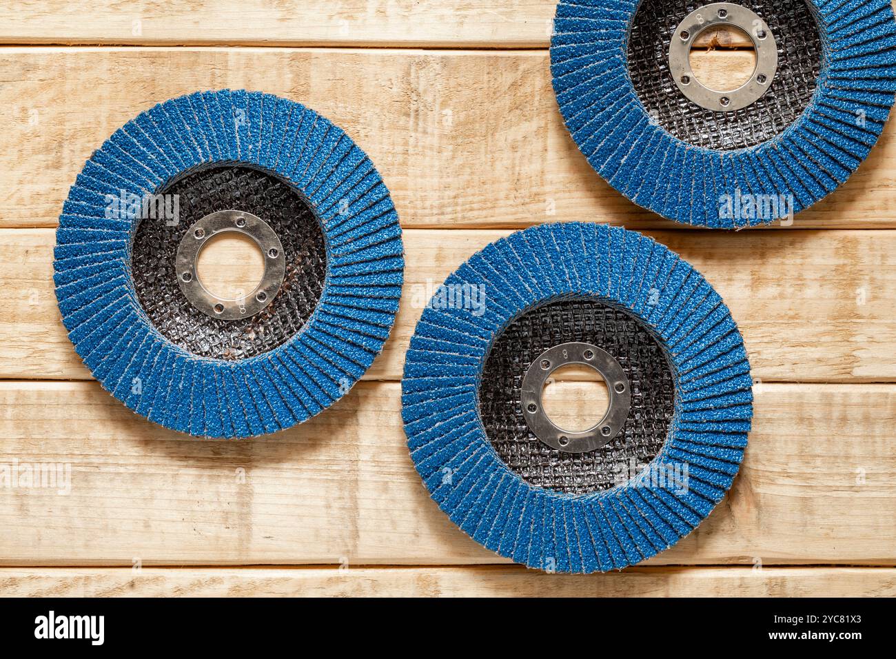 A blue abrasive grinding disc with a central metal hub and a white ...
