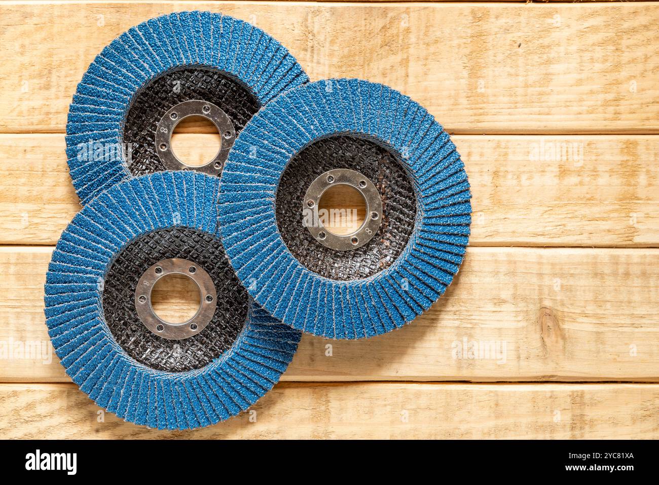 A blue abrasive grinding disc with a central metal hub and a white ...