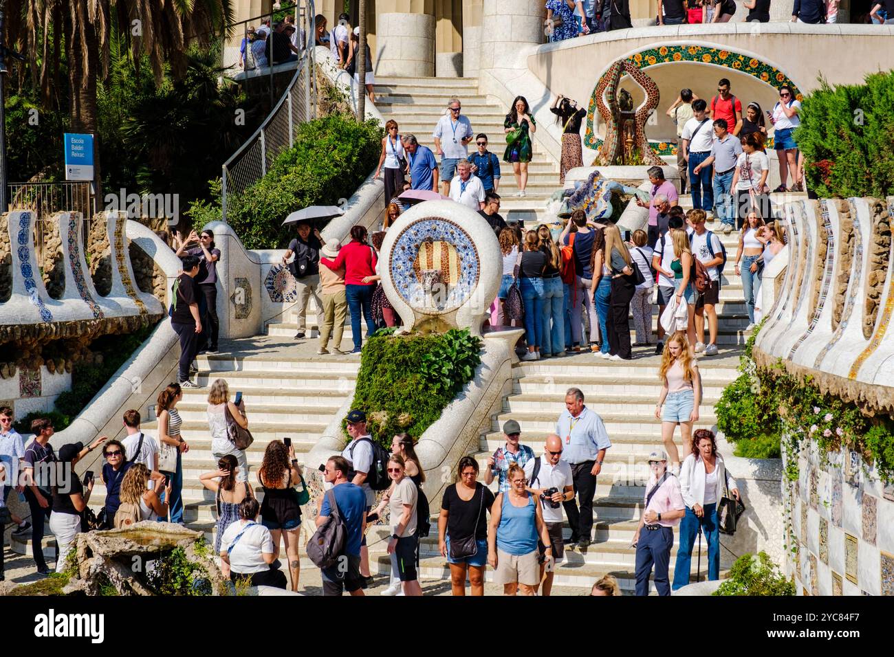 Mass tourism, overtourism, busy Parc Güell by Antoni Gaudí, escalinata ...