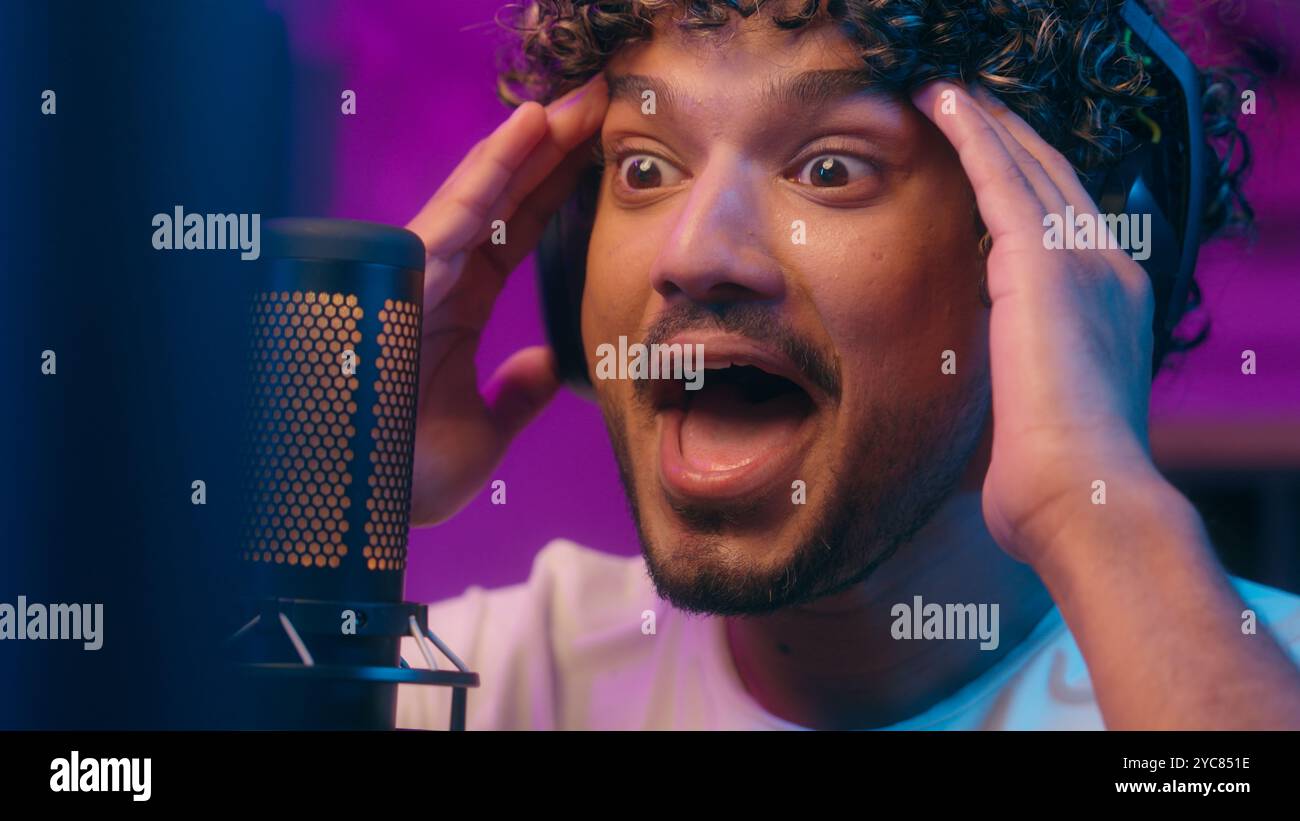 Close up Indian Arabian Latino man microphone streamer player computer ...