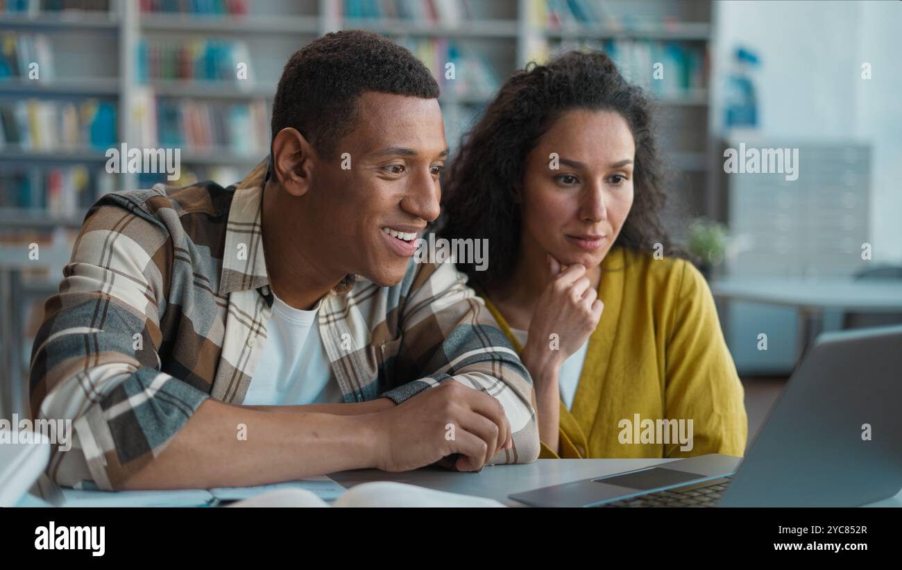 Two people African American man Indian Arabian woman team joy victory ...