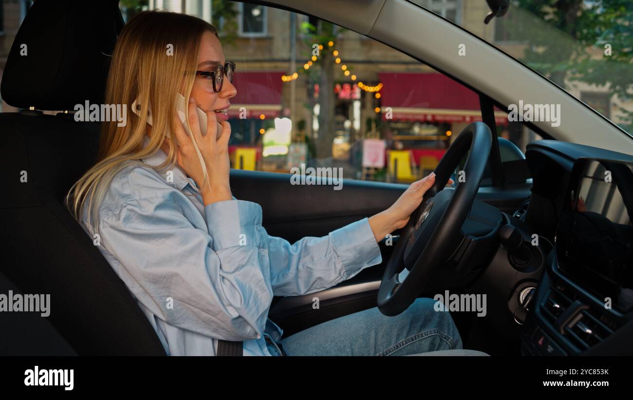 Businesswoman woman driving expensive new car talking mobile phone ...