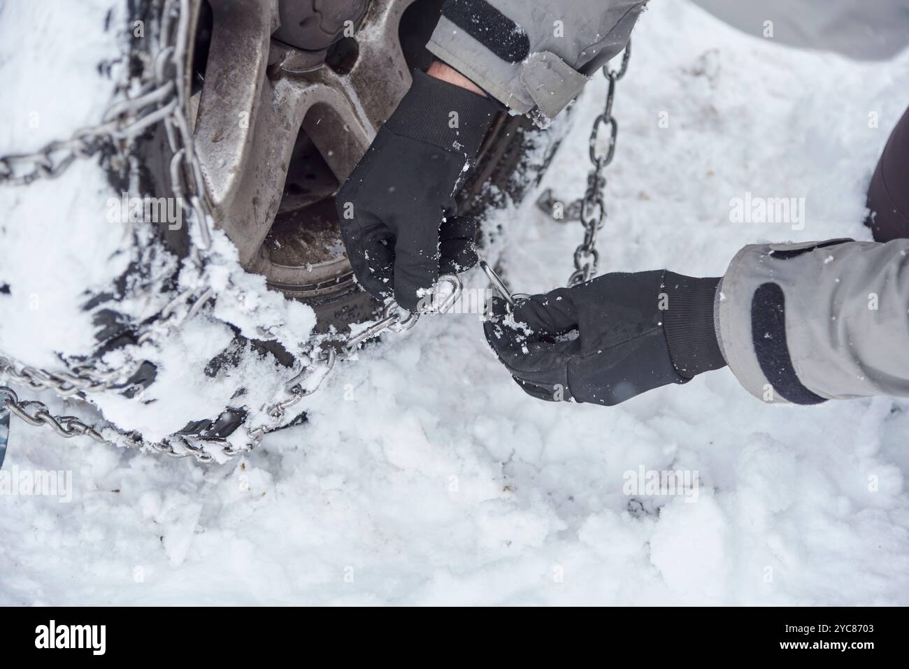 Person putting car chains hi-res stock photography and images - Alamy
