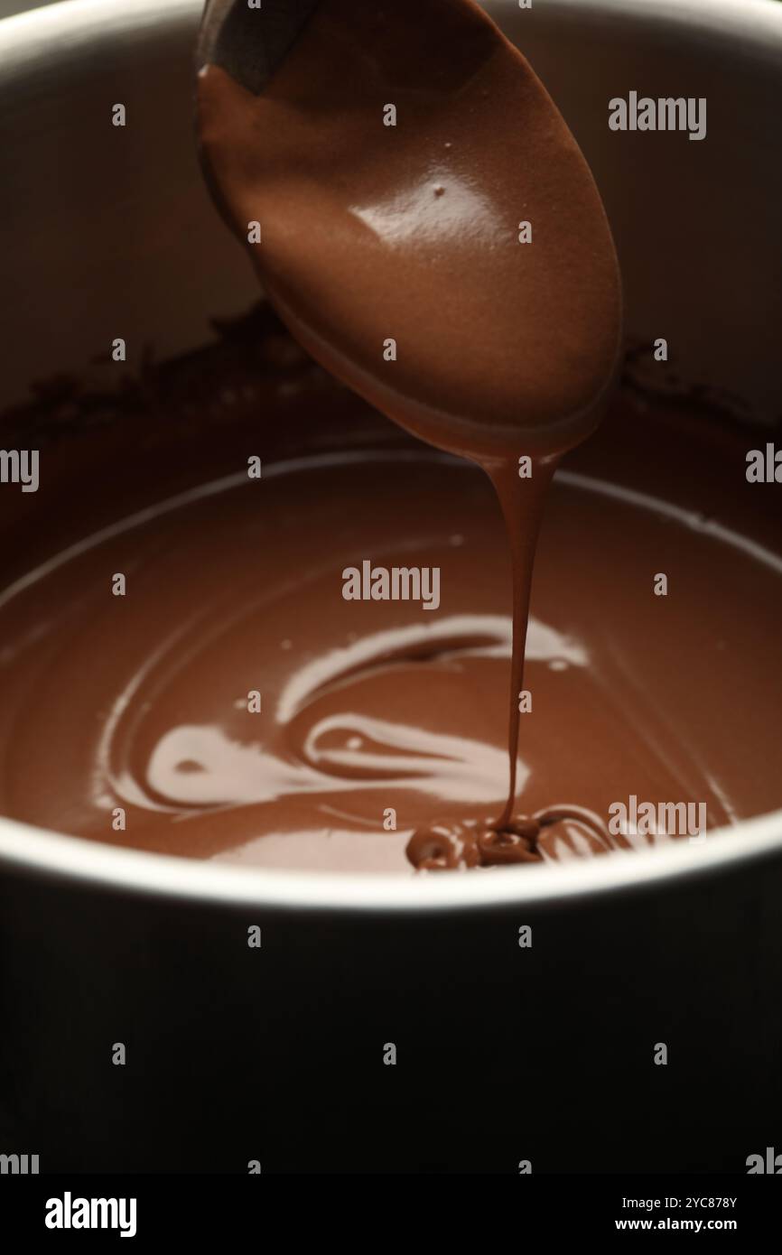 Chocolate dough dripping from spoon into bowl, closeup Stock Photo - Alamy