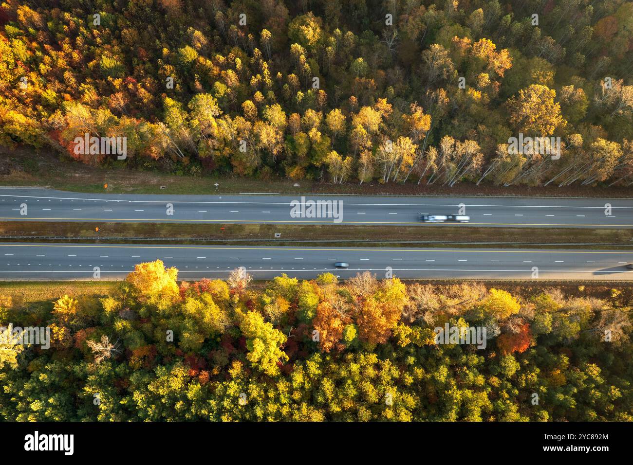 Elevated view of freeway road lanes between autumn mountain hills ...