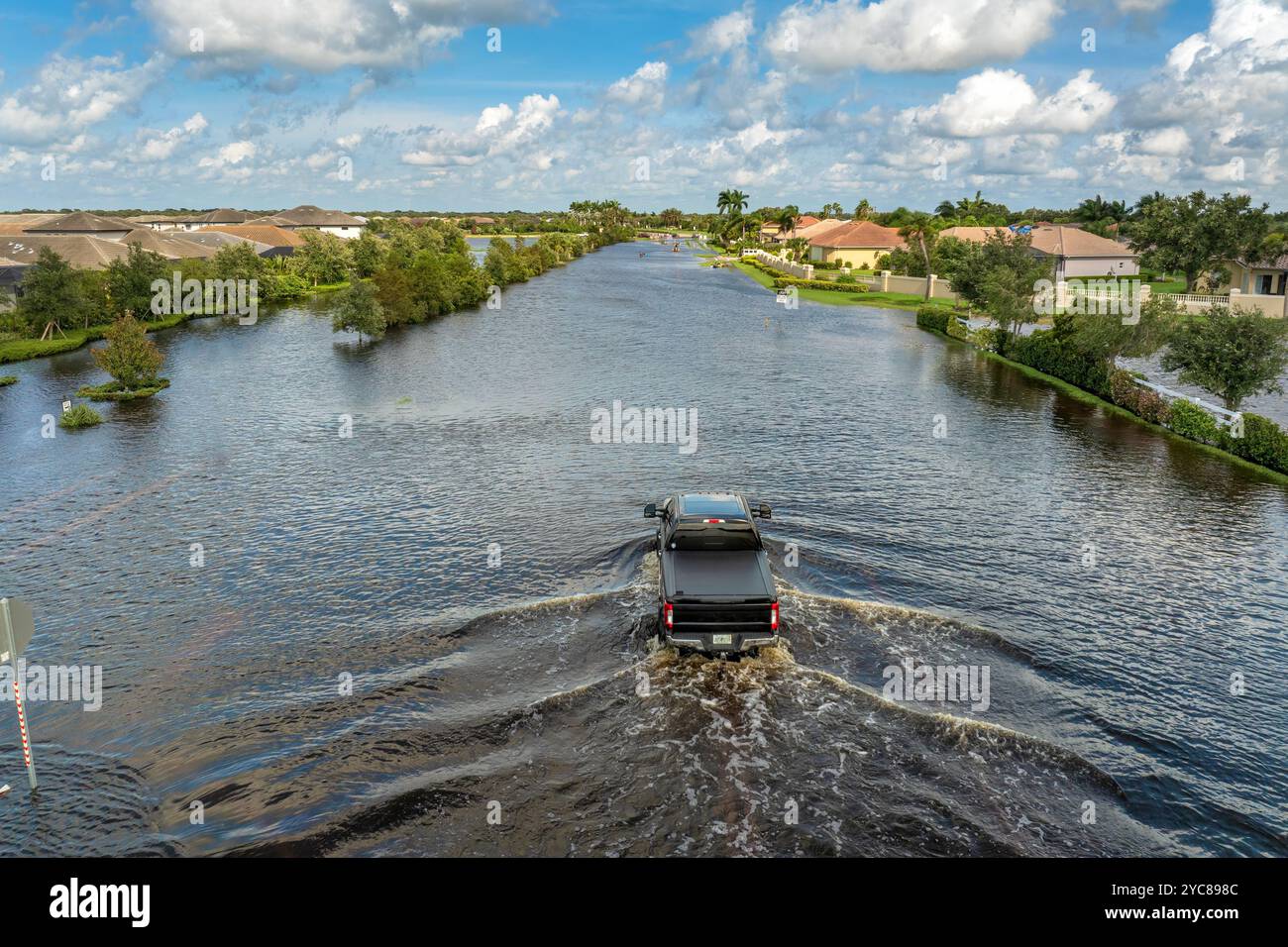 Hurricane flooded car on city street in surrounded with water Florida ...