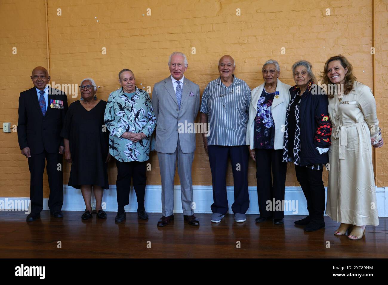 King Charles III poses for a picture with various community leaders ...