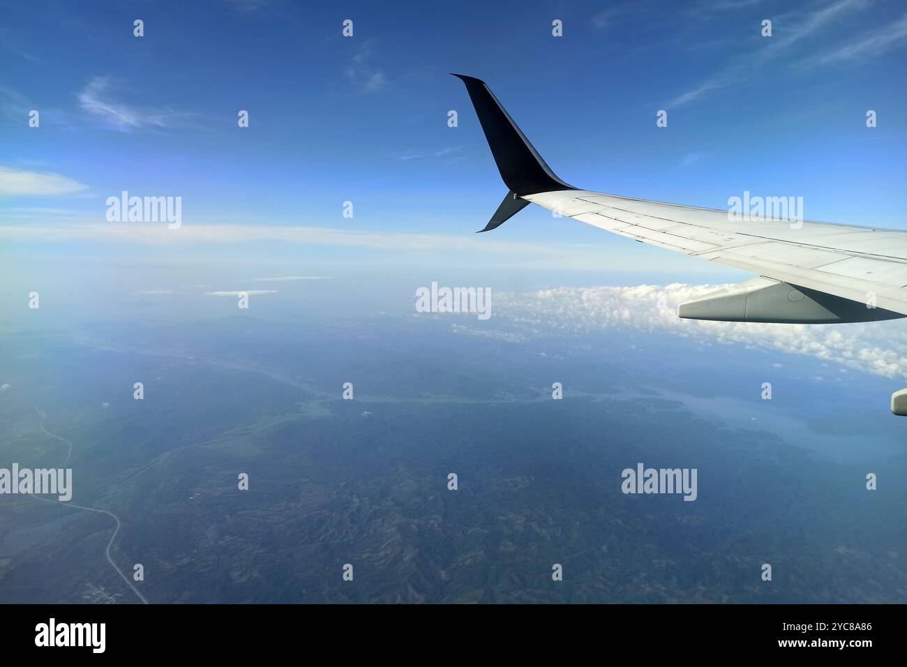 View through airplane window of commercial jet plane wing flying high ...