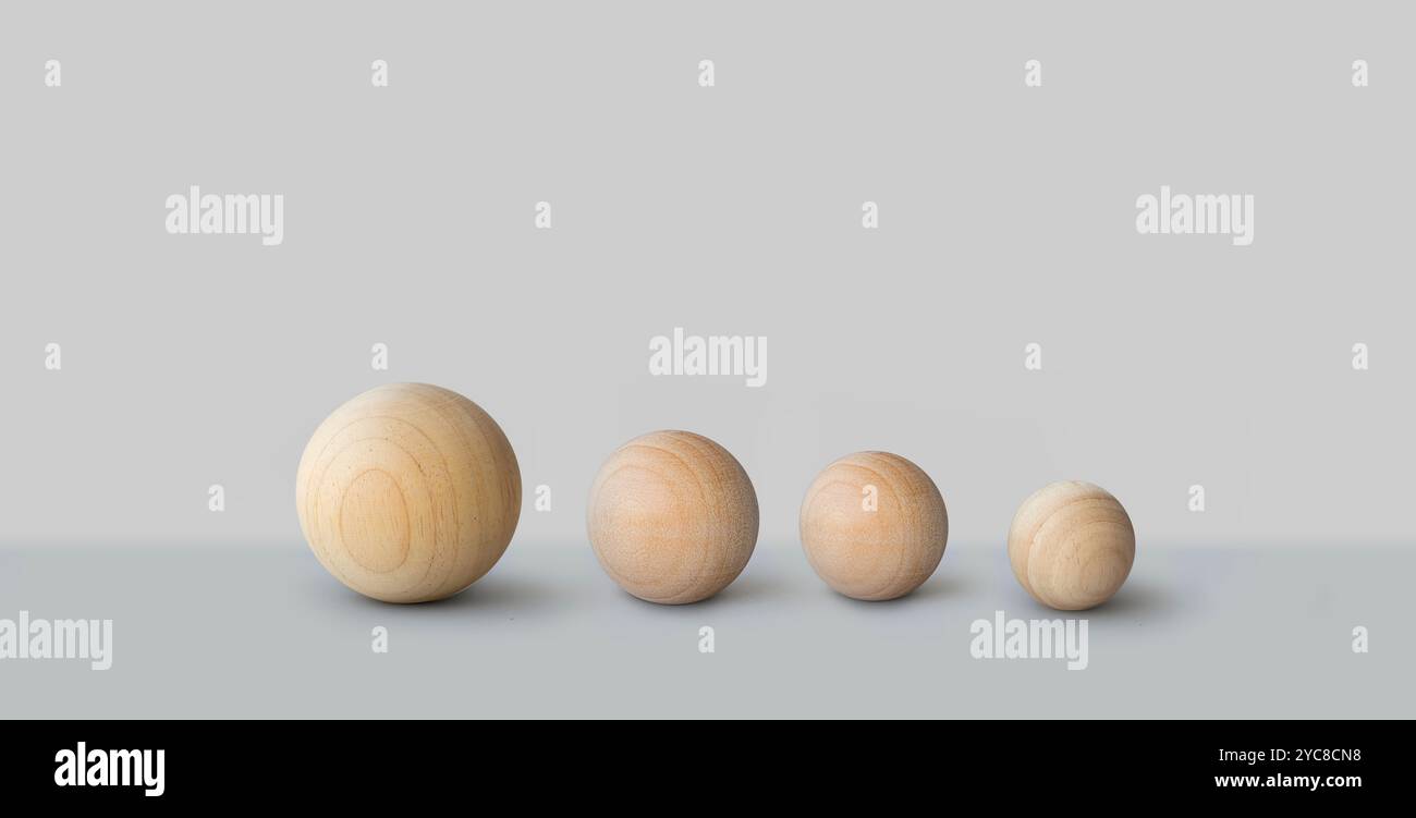 Four wooden balls in a row background Stock Photo - Alamy