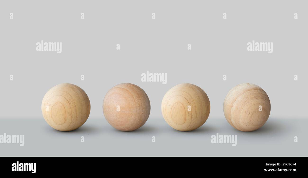 Four wooden balls in a row background Stock Photo - Alamy