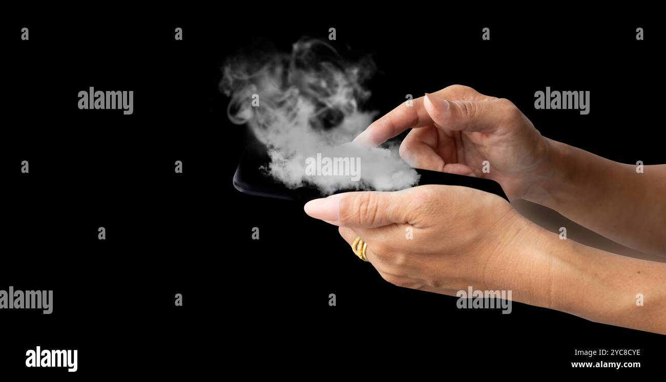 Mobile phone is hot causing smoke. Broken phone and smoke on black ...