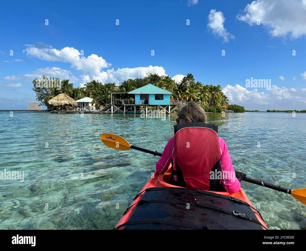 A woman, 72, paddles a kayak near Tobacco Caye, Belize Stock Photo - Alamy