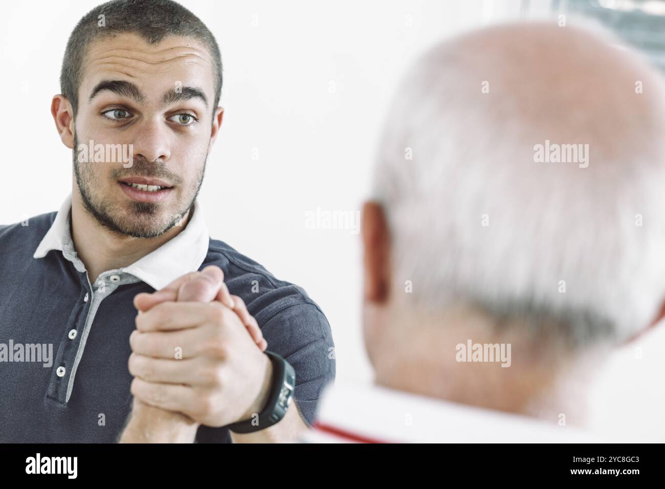 Young manager cracking his knuckles while explaining a new business ...