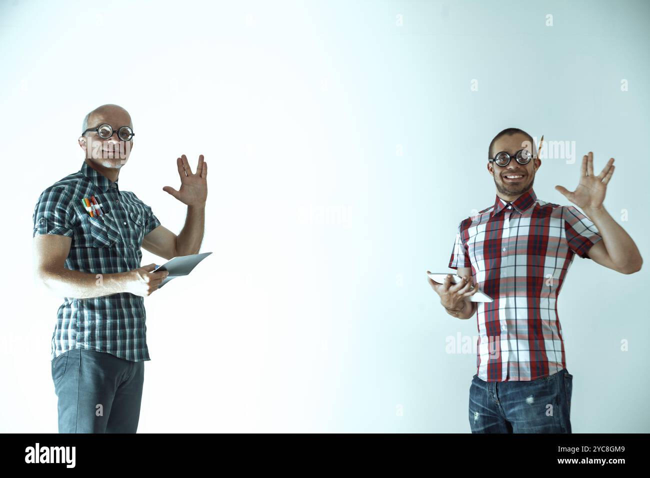 Two nerdy scientists are standing in their lab coats, holding tablets ...