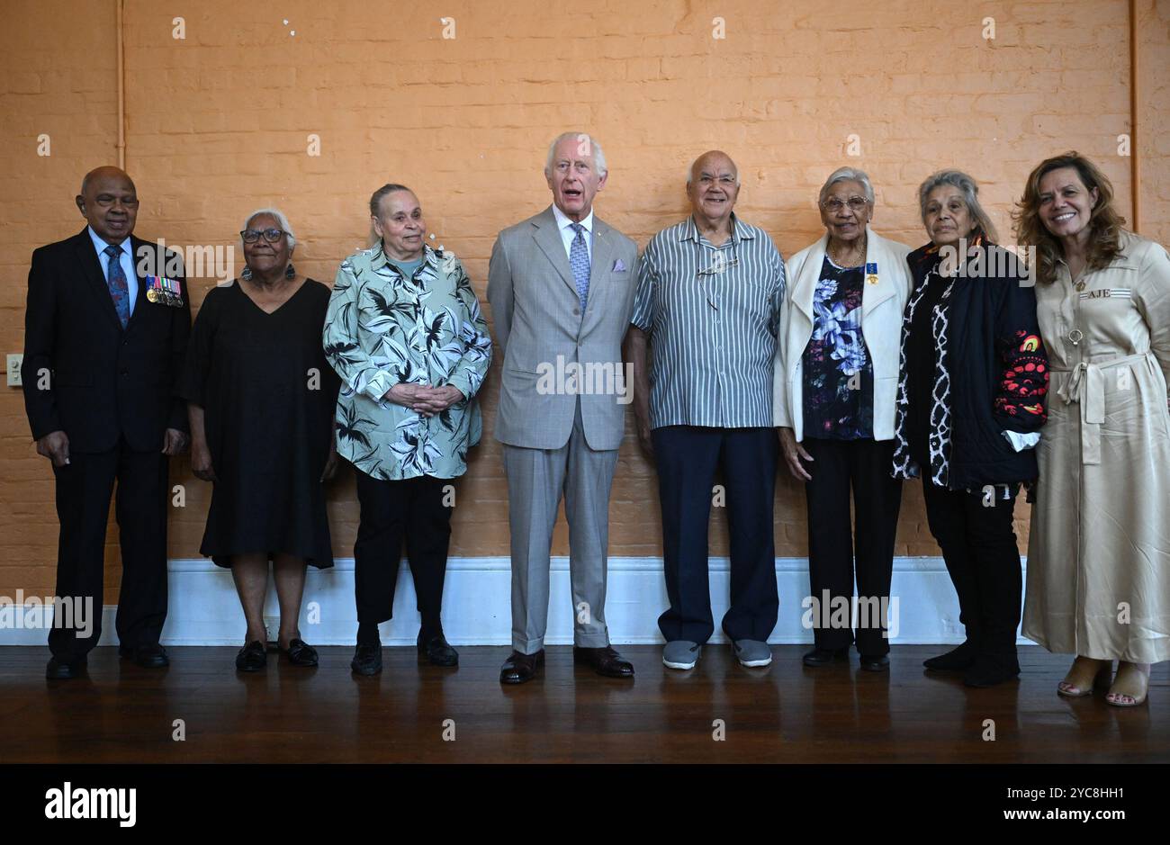 King Charles III poses for a picture with various community leaders ...