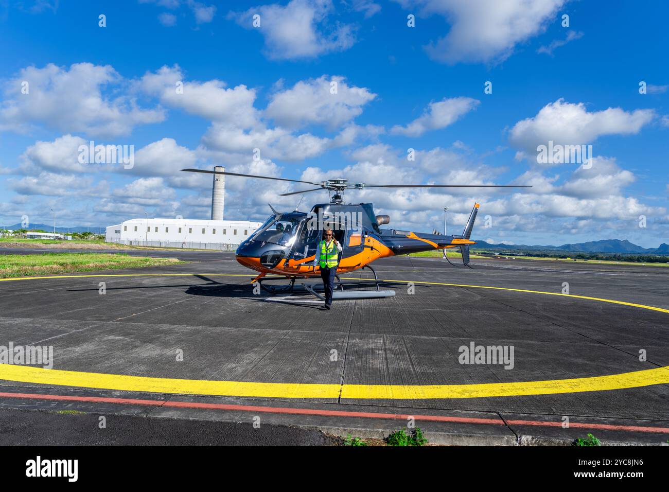 Mauritius, Mauritius - August 24, 2024: A helicopter pilot assists a ...