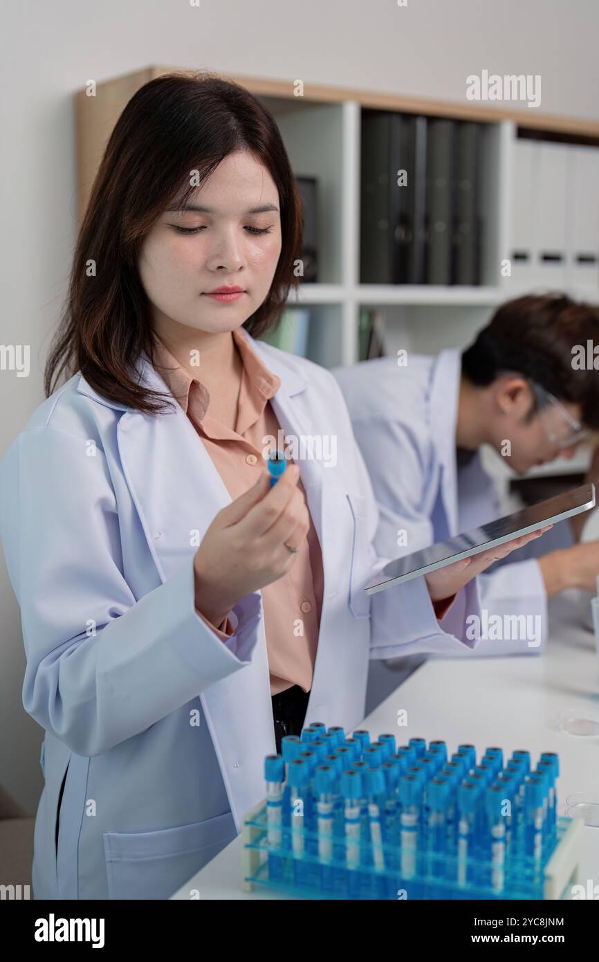 Female Researcher Examining Sample Vials for Experimental Studies Stock ...