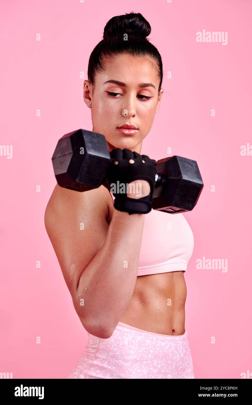 Health, dumbbells and weightlifting with woman in studio for wellness ...